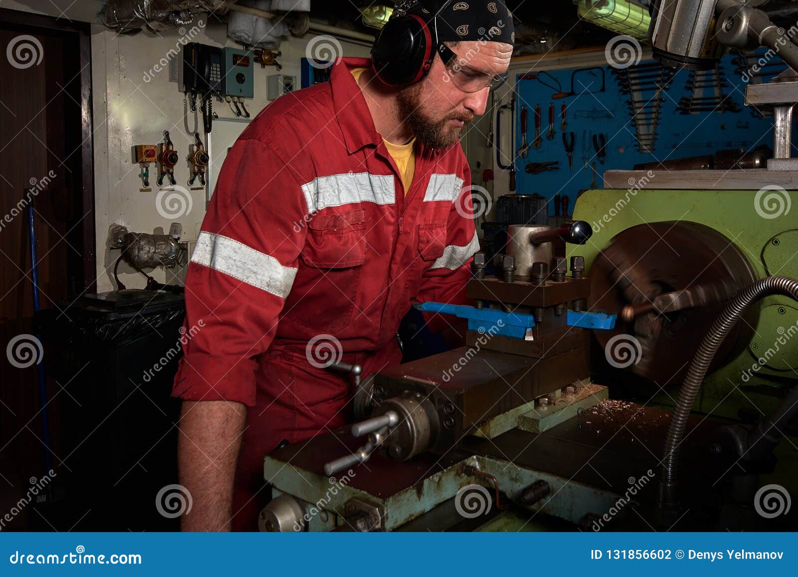 Worker in Red Uniform Operating in Manual Lathe in Metal Big Workshop ...