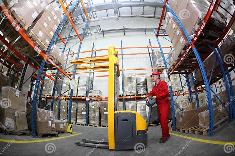 Worker in Red Uniform at Work in Warehouse Stock Photo - Image of ...