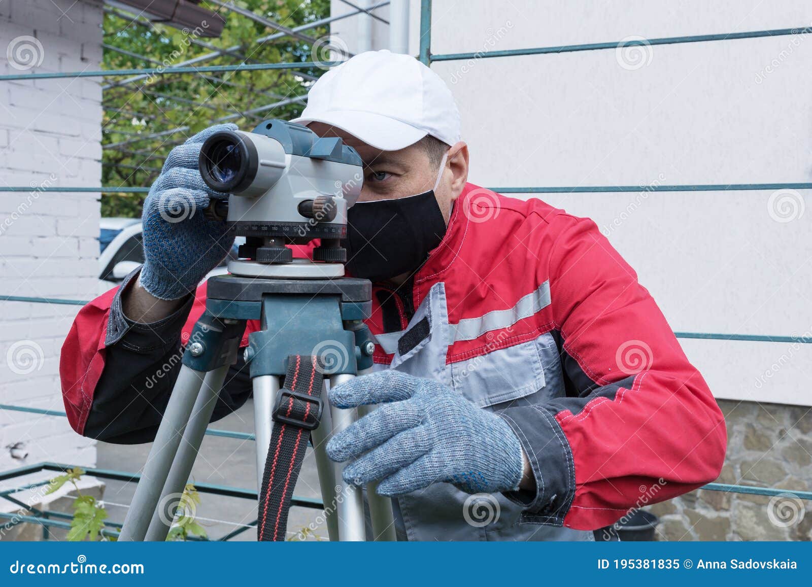 Worker in Red Workwear Looks in Engineering Level. Stock Image - Image ...