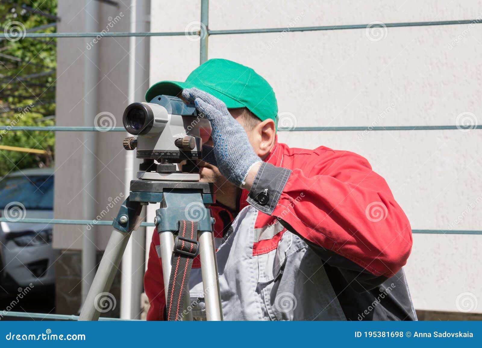 Worker in Red Workwear Looks in Grey Engineering Level. Stock Photo ...