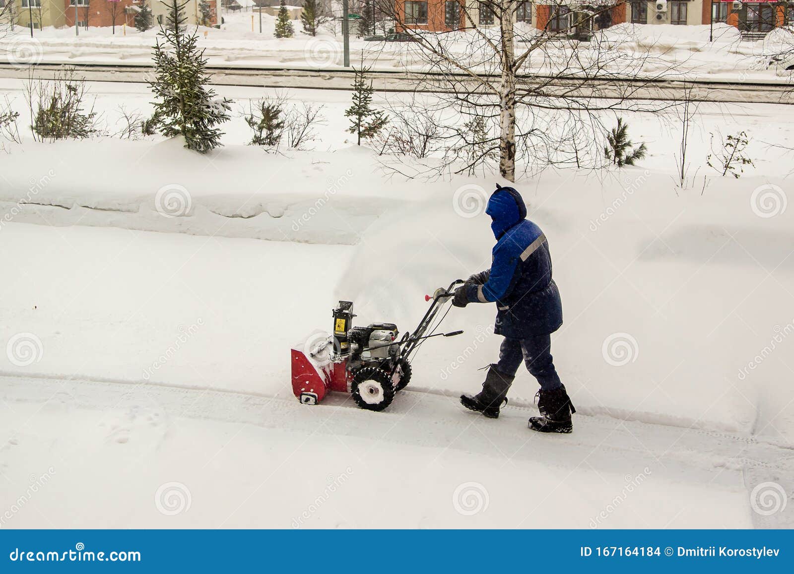 Worker Removes Snow from the Yard Using a Snowplow Stock Photo - Image ...