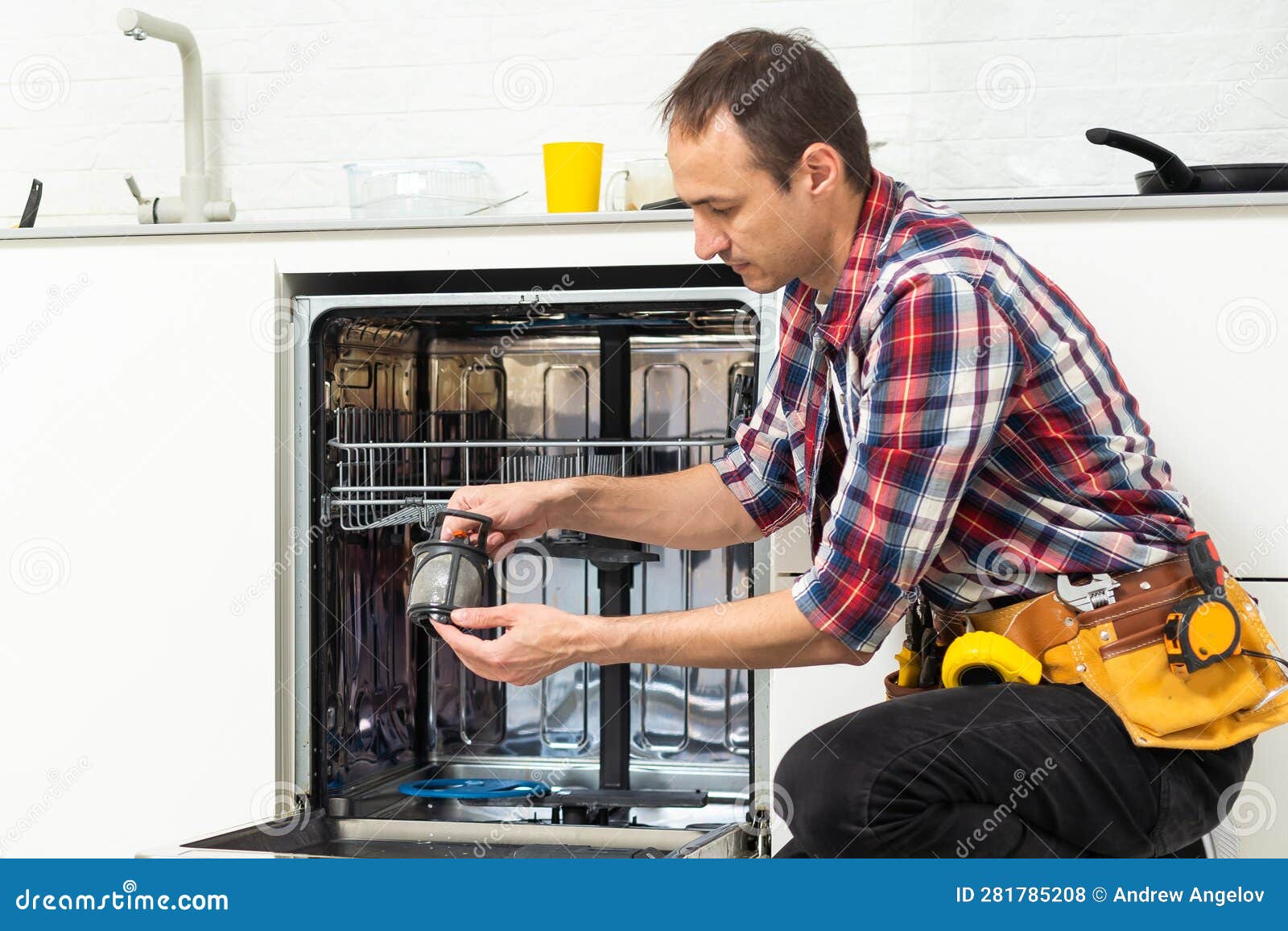 Worker Repairing the Dishwasher in the Kitchen Stock Photo - Image of ...