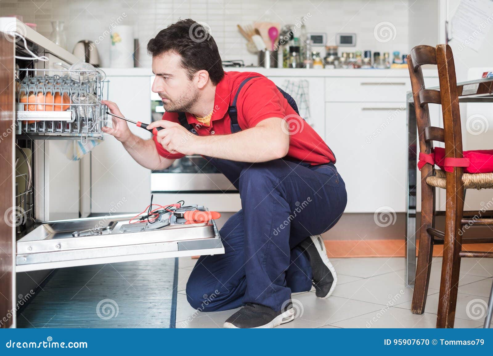 Worker Repairing the Dishwasher in the Kitchen Stock Photo - Image of ...
