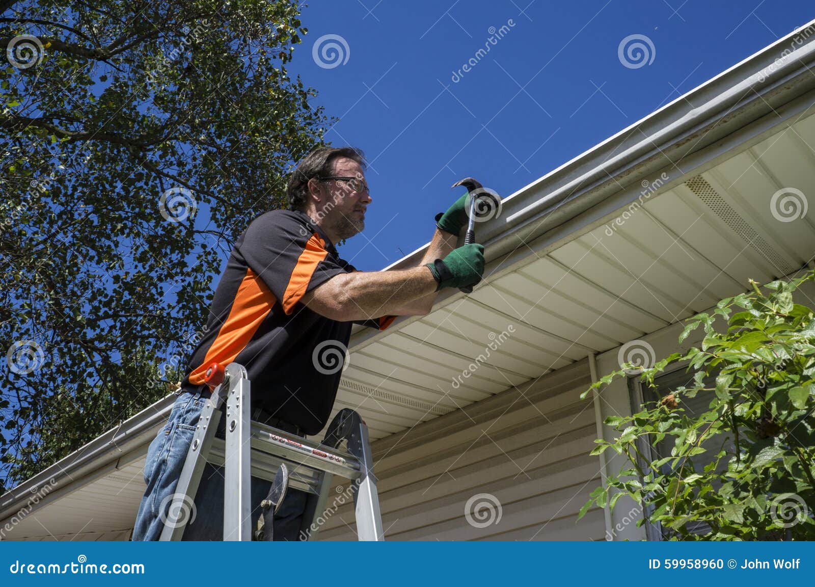 Worker Repairing a Gutter on a Customers Home Stock Photo - Image of ...