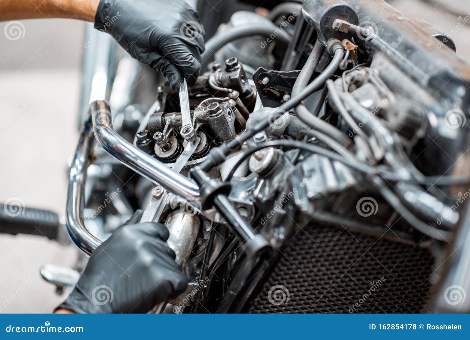 Worker Repairing Motorcycle Engine at the Workshop Stock Photo - Image ...