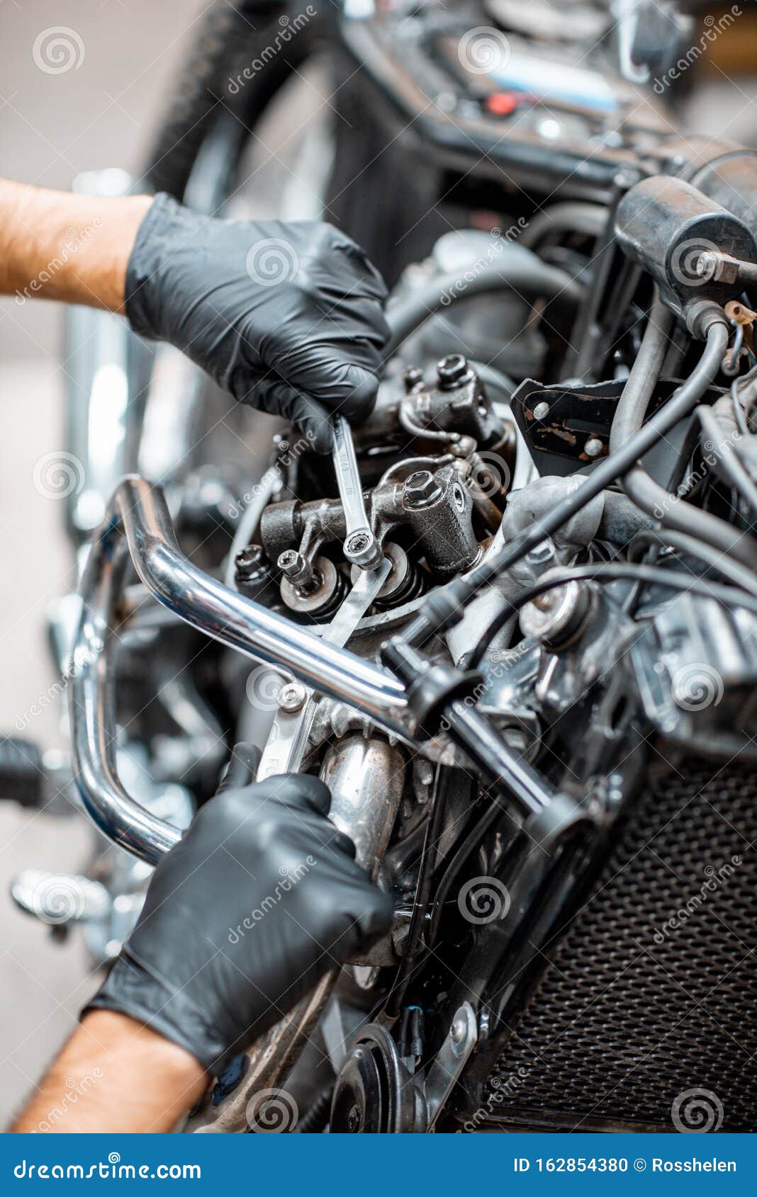 Worker Repairing Motorcycle Engine at the Workshop Stock Photo - Image ...