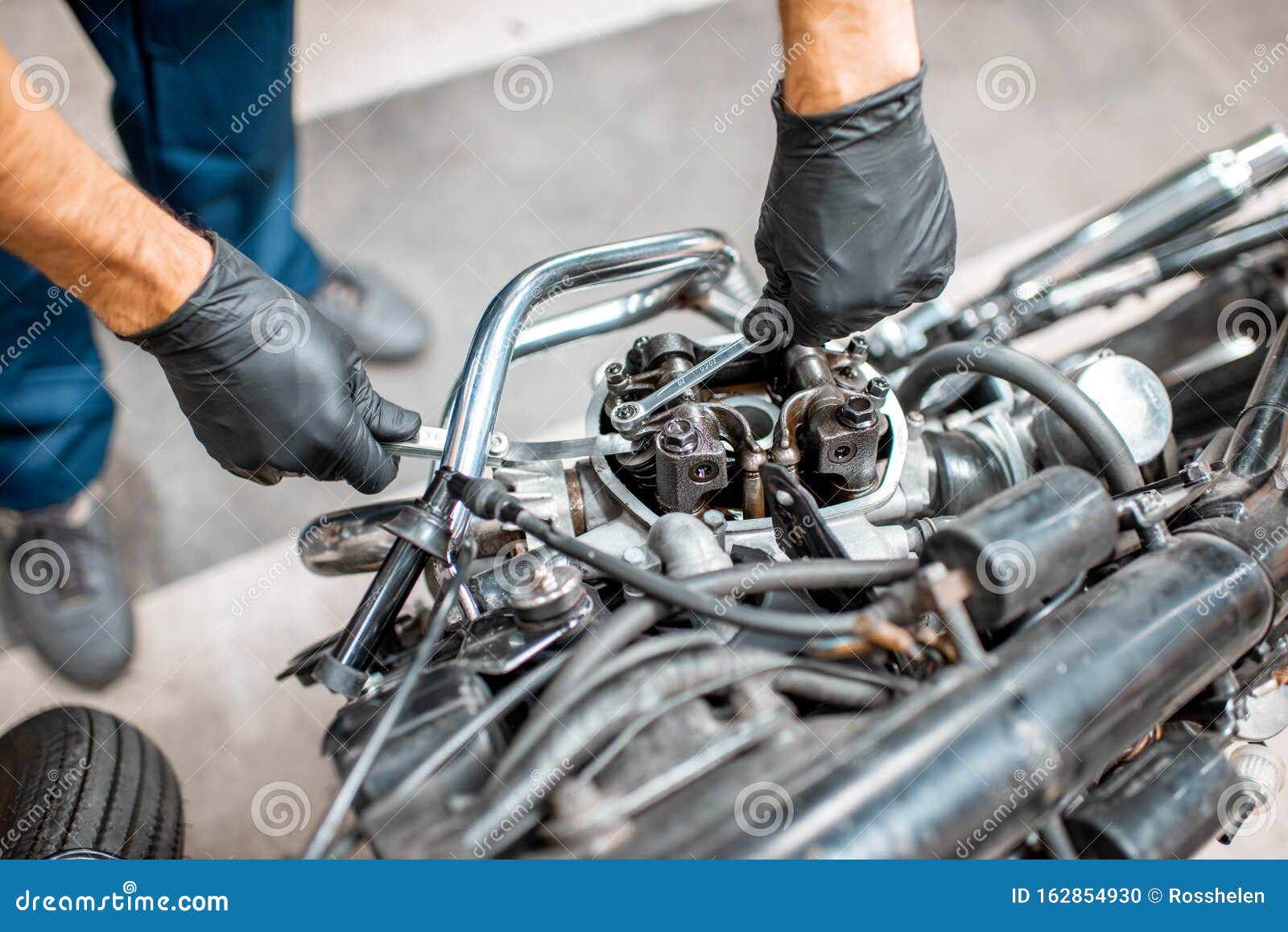 Worker Repairing Motorcycle Engine at the Workshop Stock Photo - Image ...