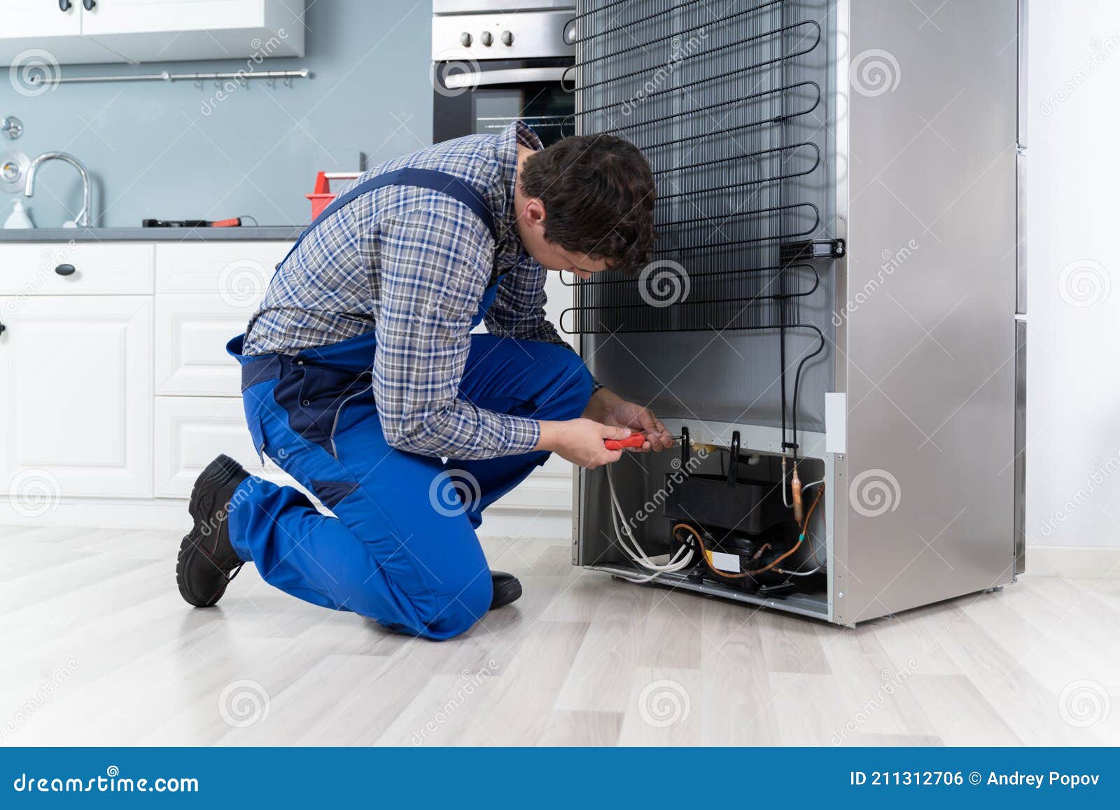 Worker Repairing Refrigerator in House Stock Photo - Image of home ...