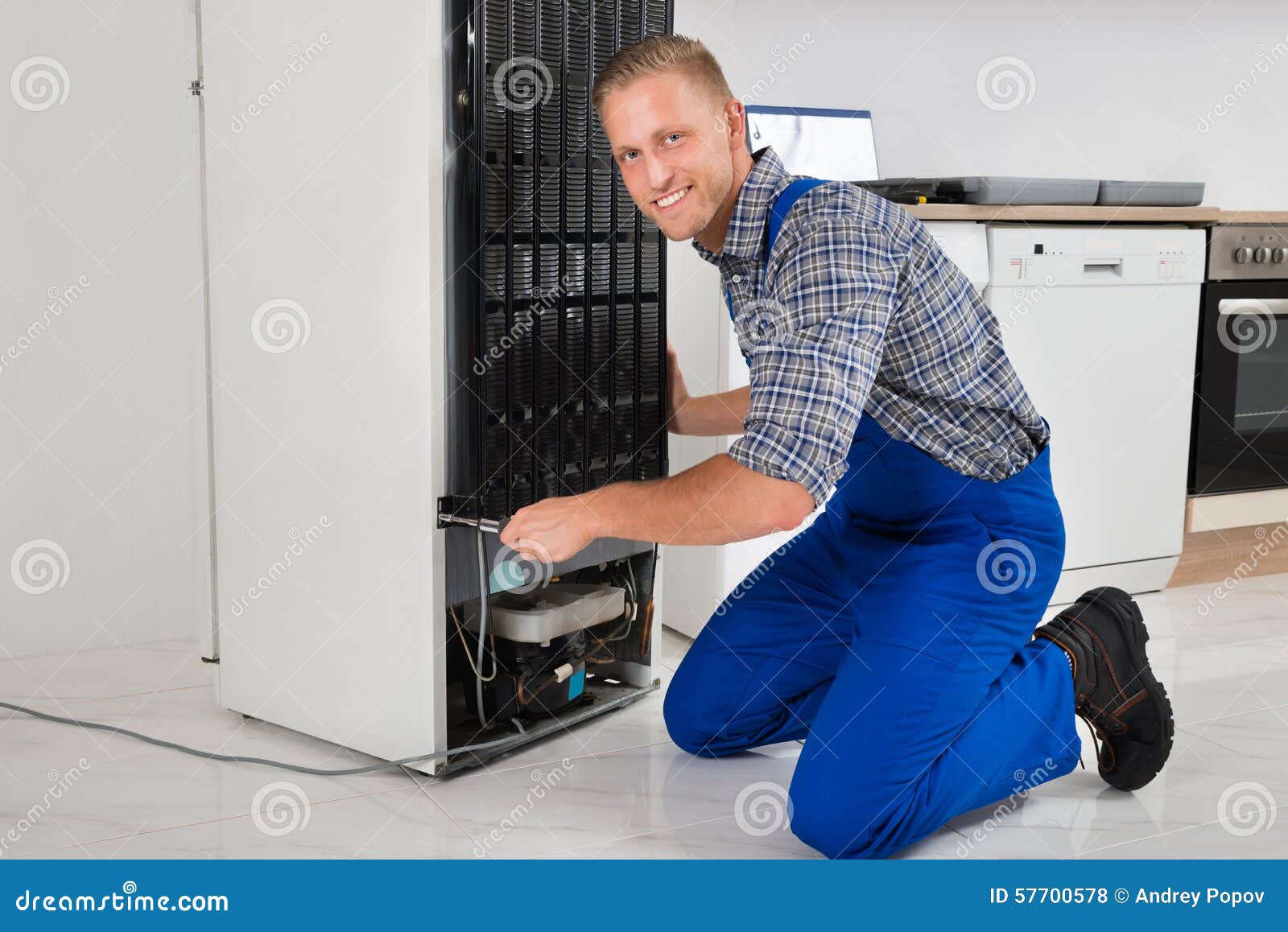 Worker Repairing Refrigerator in House Stock Photo - Image of check ...