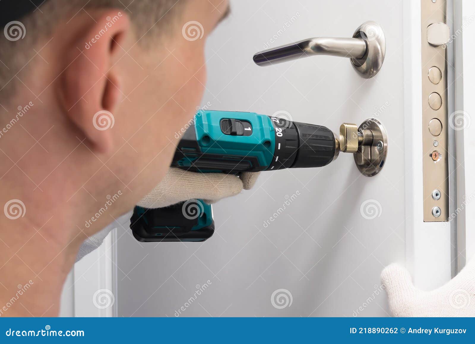 A Worker Repairs the Closing Mechanisms at the Door Stock Photo - Image ...