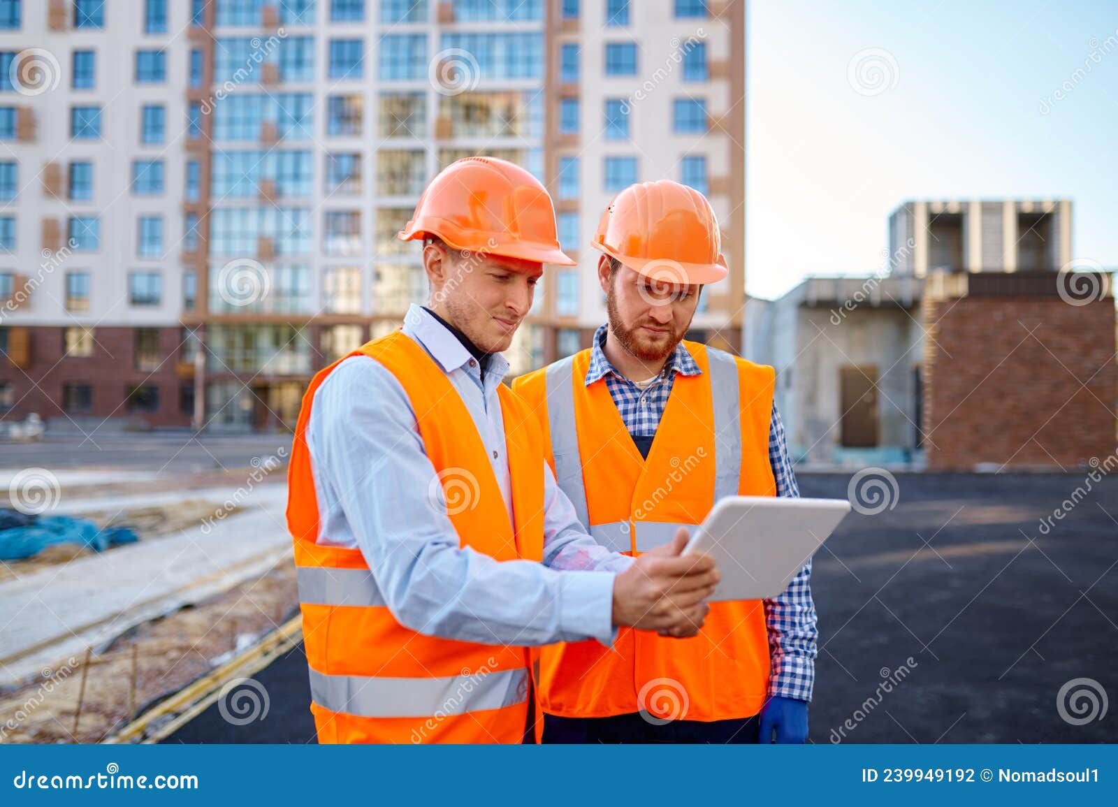 Worker Reporting To Contractor at Construction Site Stock Photo - Image ...