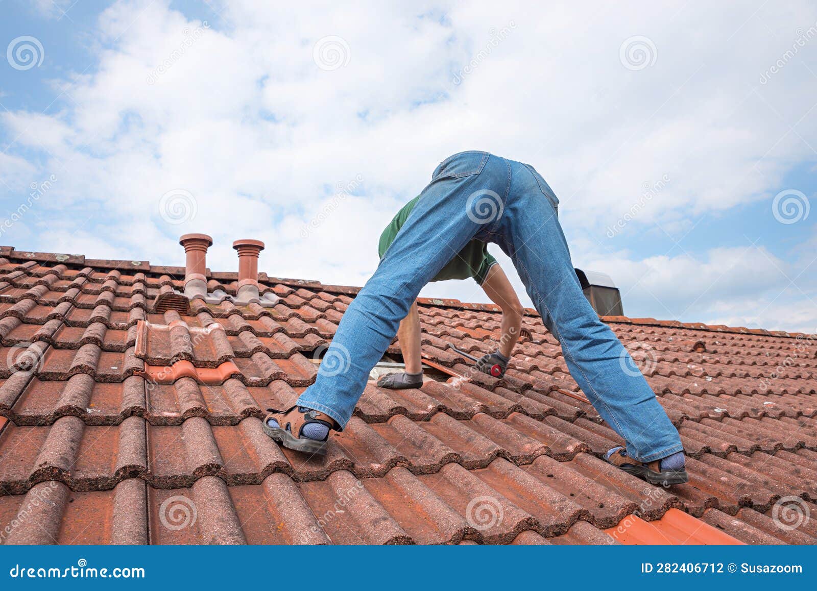 Worker on the Rooftop, Replacing Broken Tiles with New Shingles Stock ...