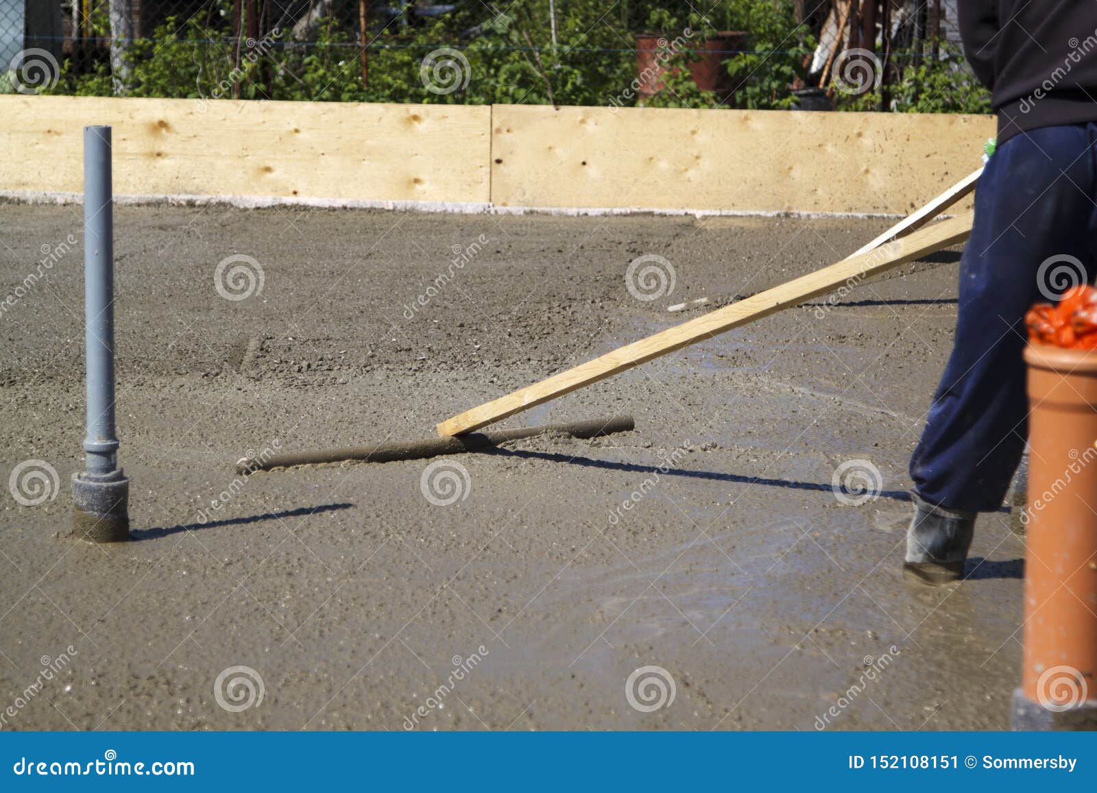 Worker in Rubber Boots Stands in Uncluttered Cement and Leveling Stock ...