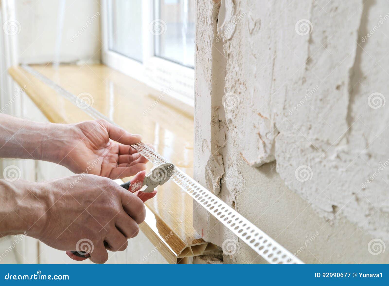 Worker`s Hands are Cutting a Perforated Aluminum Corner. Stock Image ...