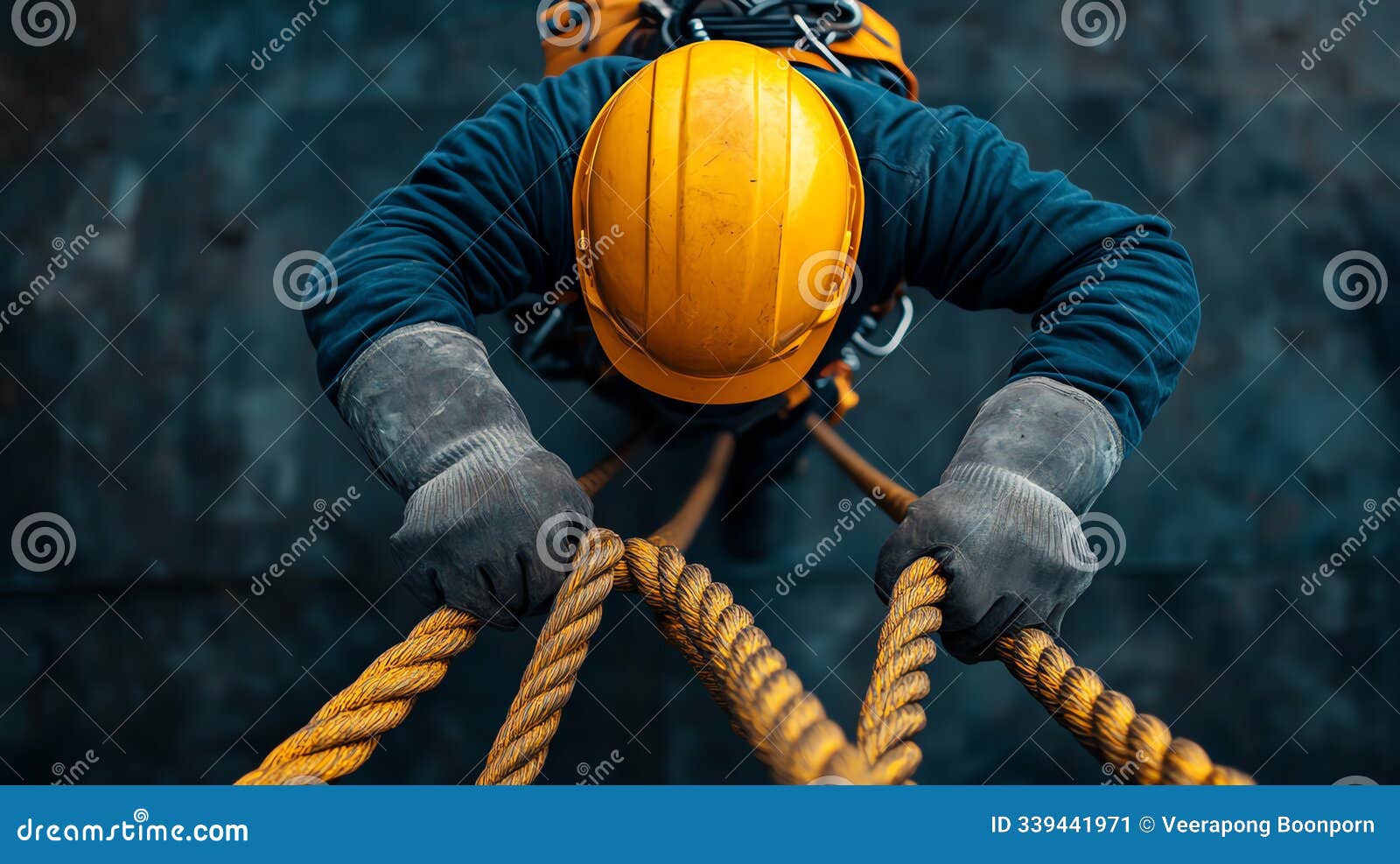 Worker with Safety Gear Climbing Using Ropes in a High-risk Environment ...