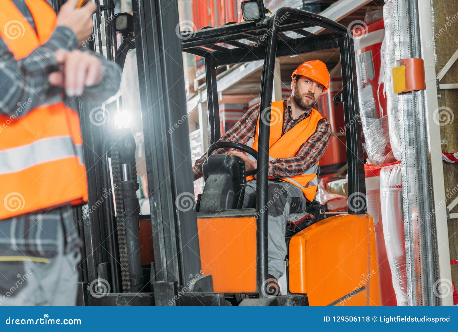 Worker in Safety Vest and Helmet Sitting in Forklift Machine Stock ...