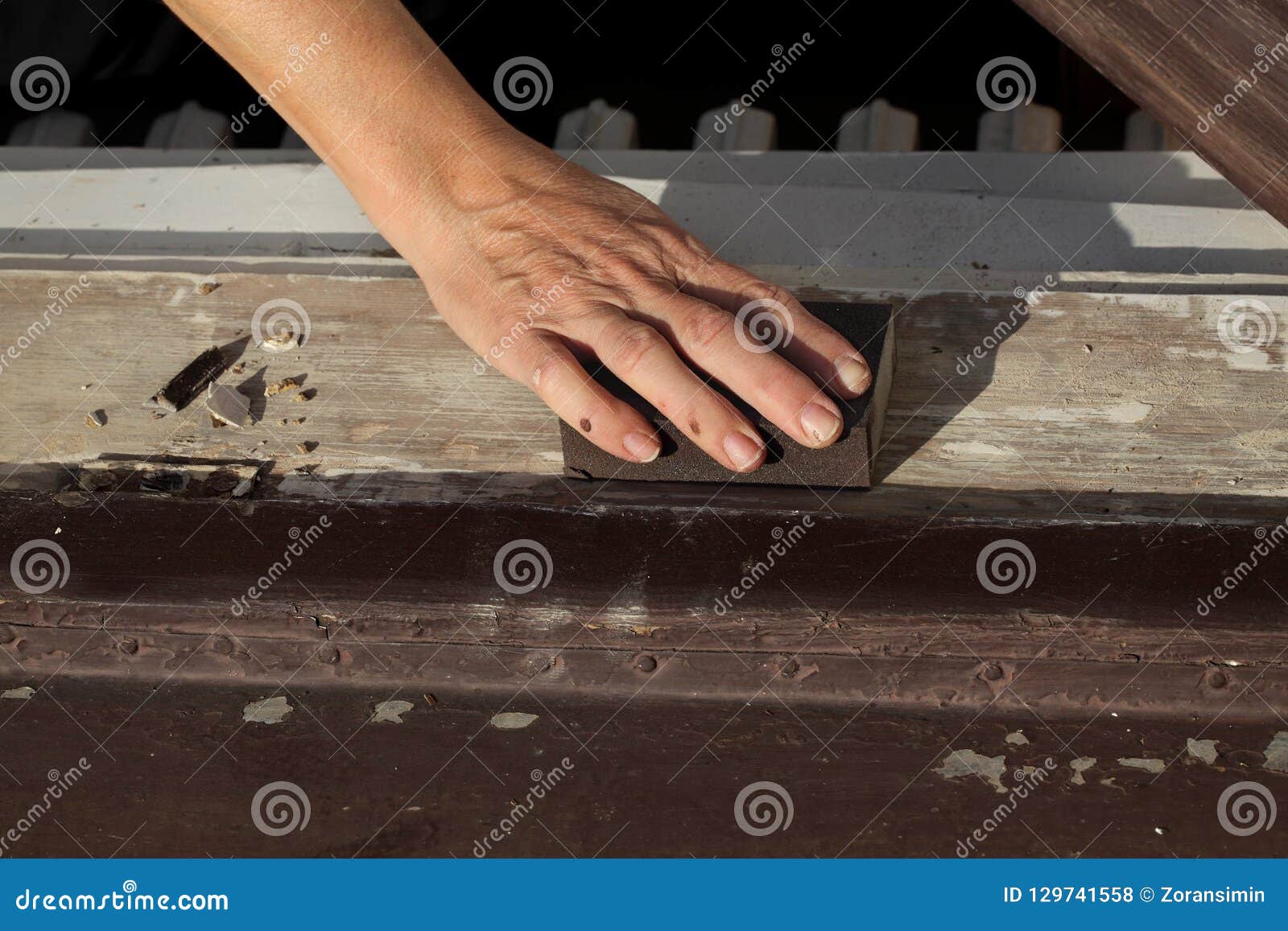 Worker sanding old window stock photo. Image of construction - 129741558