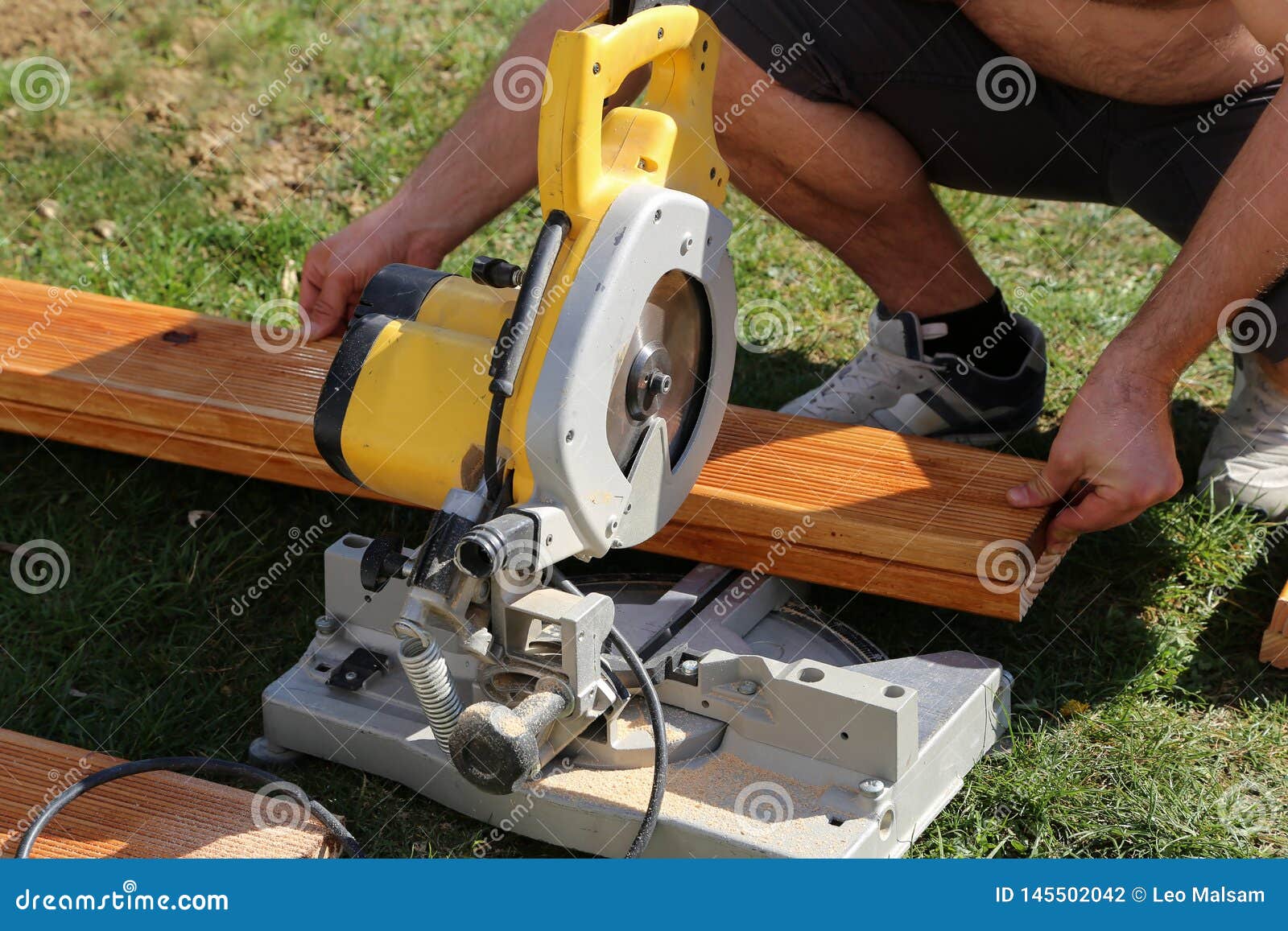 A Worker Saw Wood with a Chop Saw Stock Photo - Image of people ...