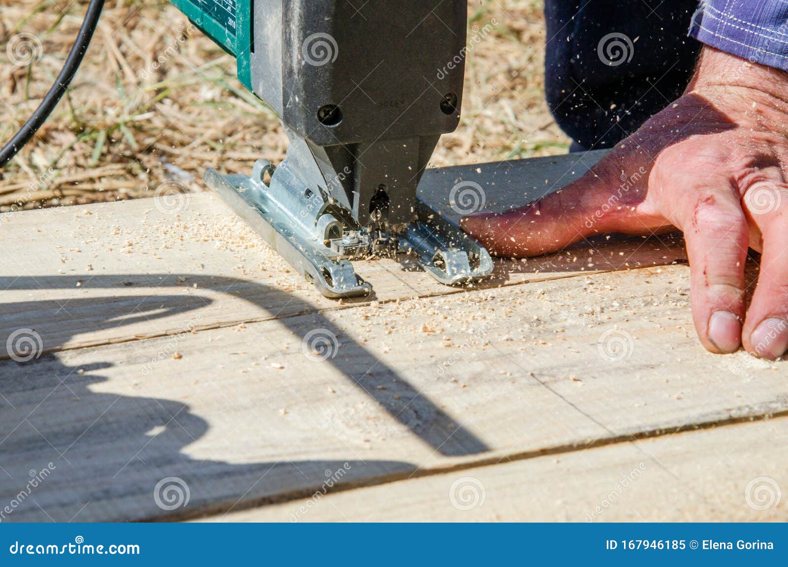 Worker Sawing Boards with a Jigsaw at a Construction Site Stock Image ...