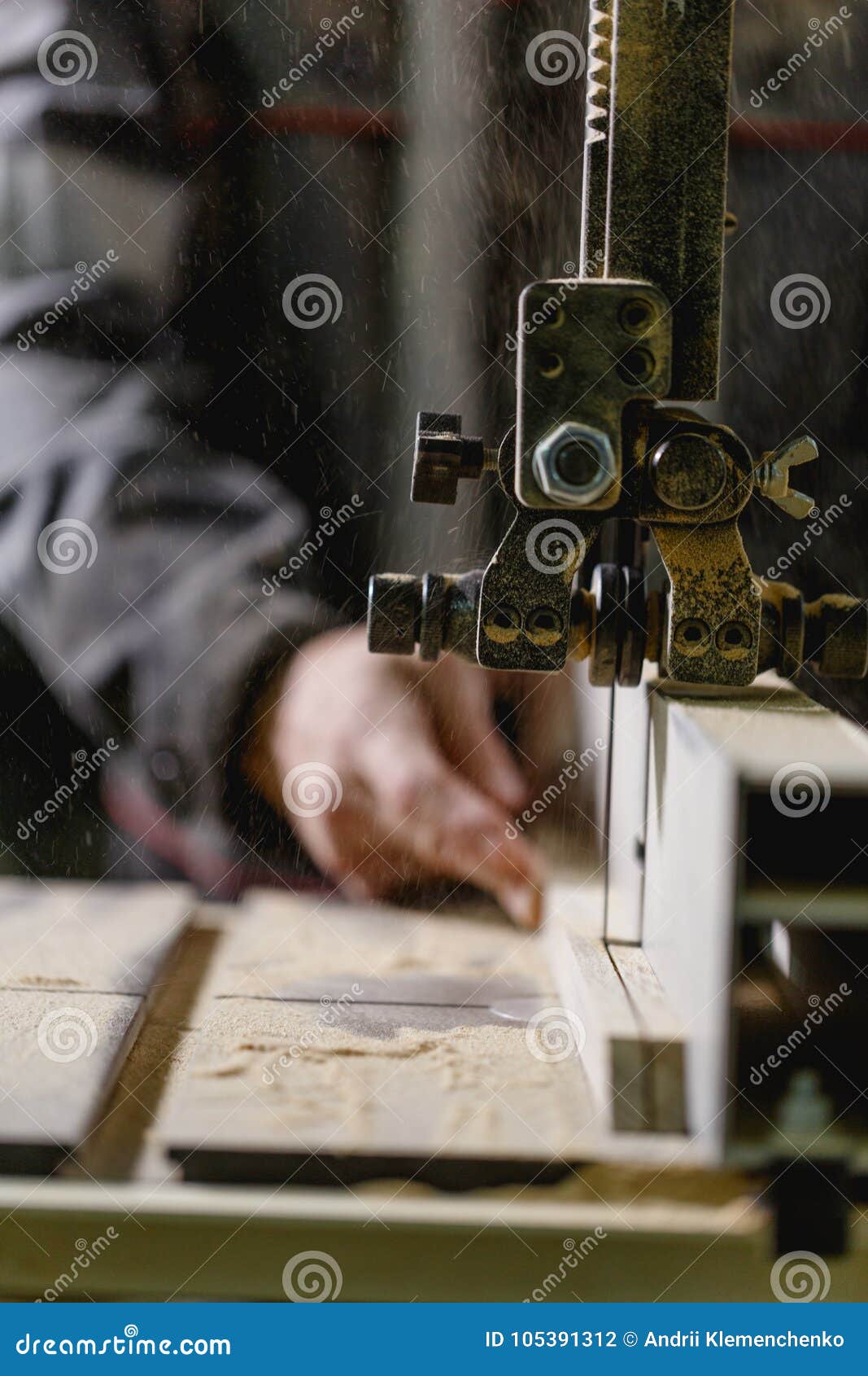 The Worker Saws the Workpiece on a Jig Saw and Sawdust is Flying. Front ...