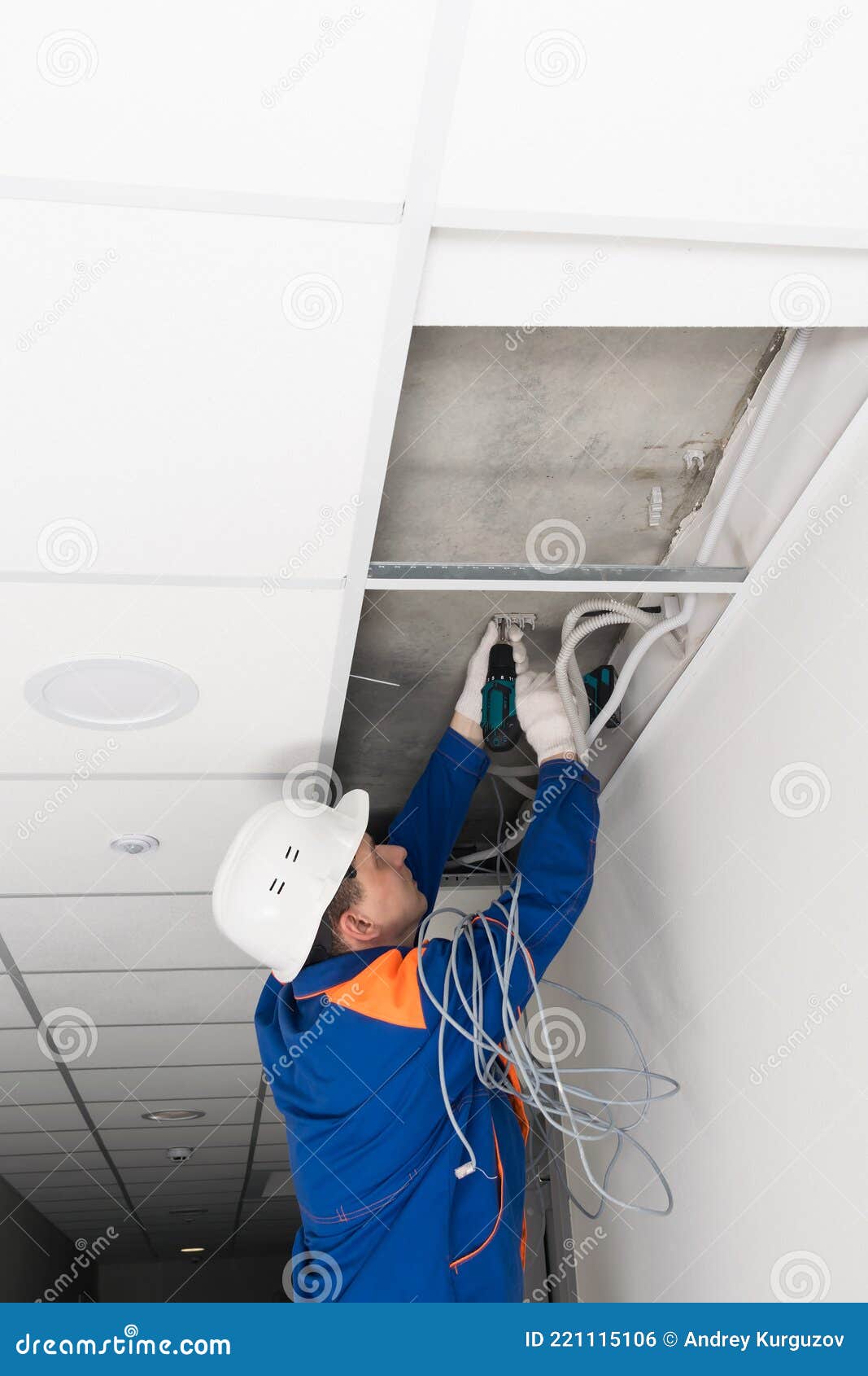 A Worker Screws the Wire Holders To the Ceiling Stock Photo - Image of ...