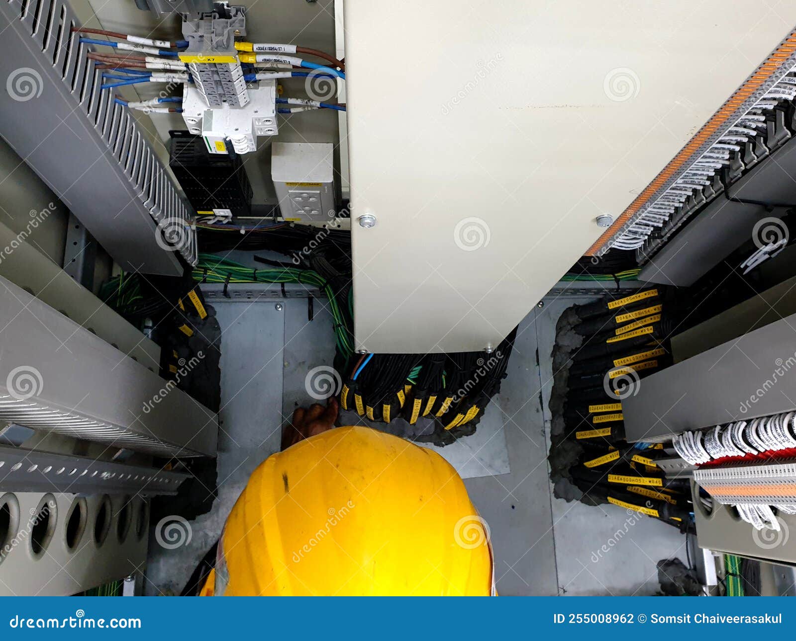 A Worker Sealing the Floor of the Electrical Control Cubicle. Stock ...