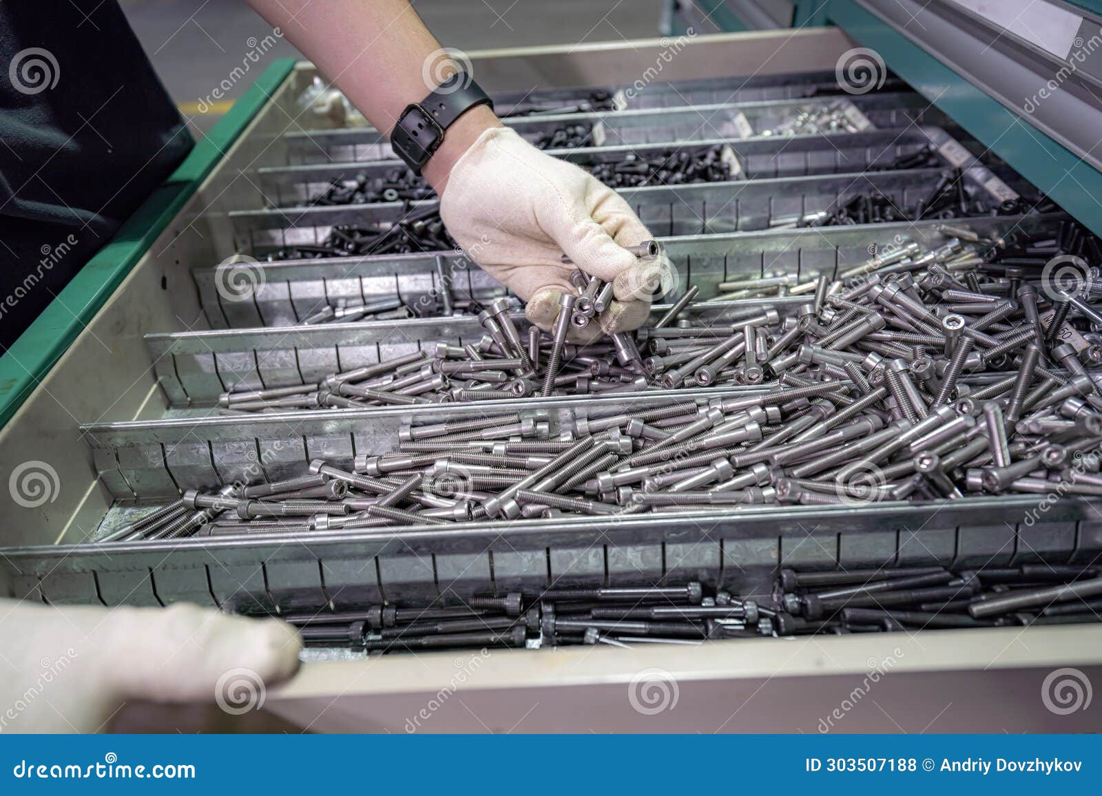 A Worker Selects Bolts in a Box To Connect Technical Parts Stock Photo ...