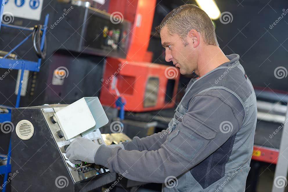 Worker Setting Up Factory Equipment Stock Image - Image of engineer ...