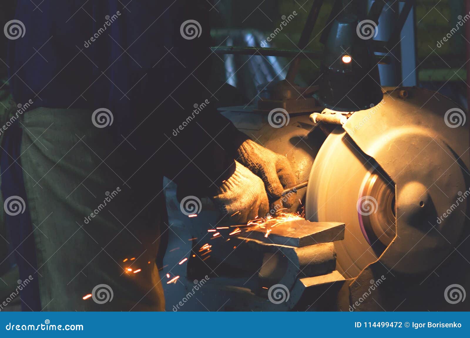 The Worker Sharpens the Tool on a Rotating Grinding Wheel Stock Photo ...