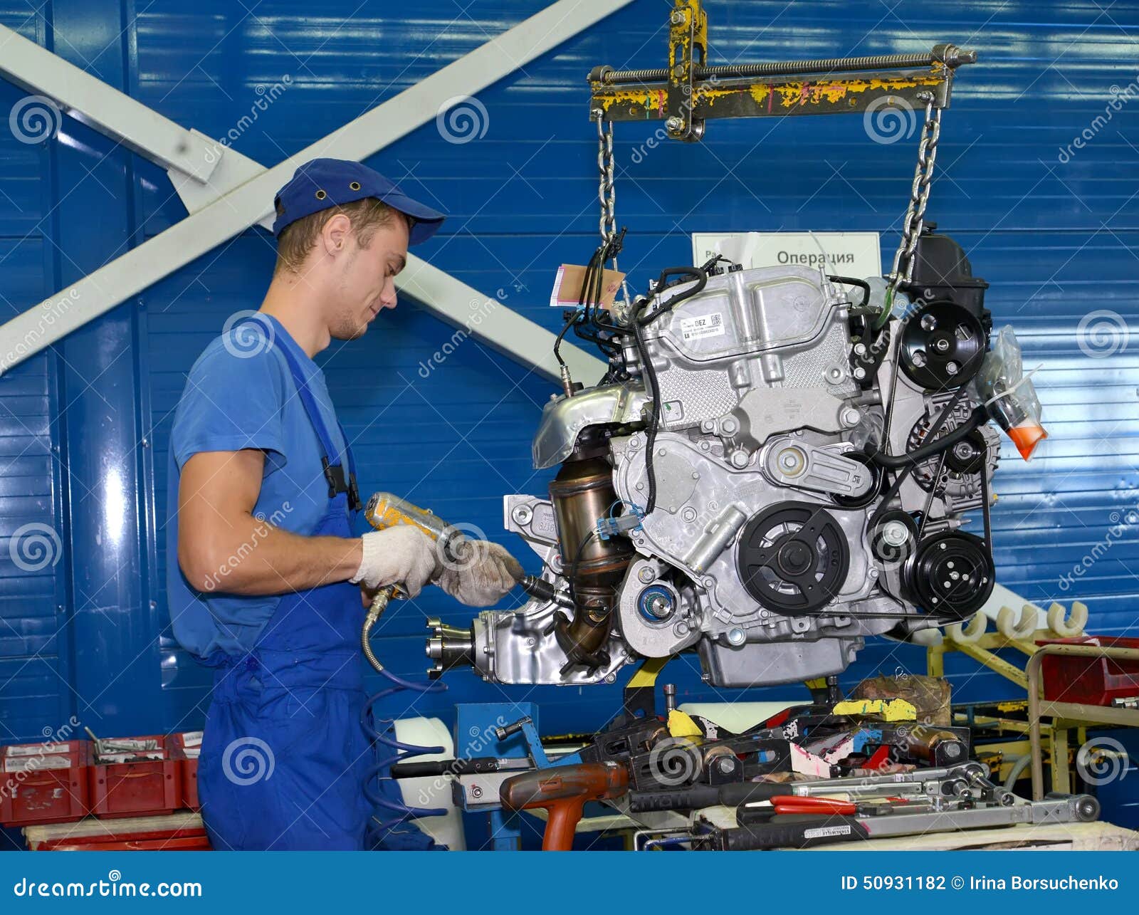 The Worker on a Site of Subassembly of Automobile Engines. Assembly ...