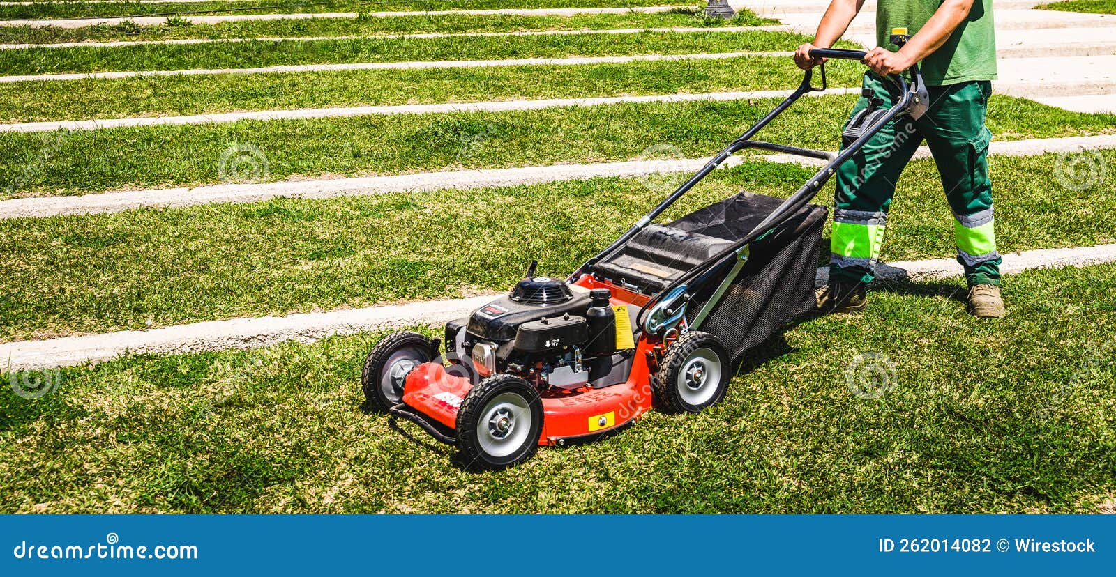 Worker in a Special Uniform Doing Lawn Mowing in the Yard Stock Photo ...