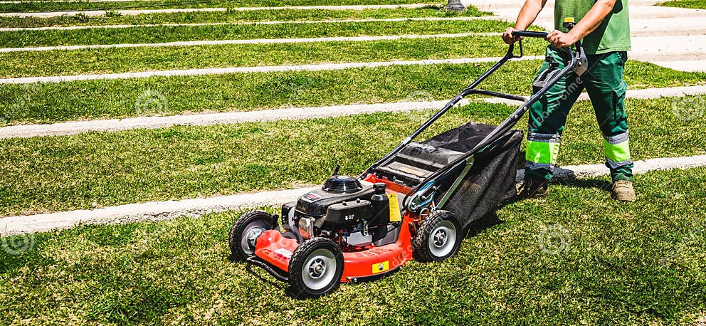 Worker in a Special Uniform Doing Lawn Mowing in the Yard Stock Photo ...