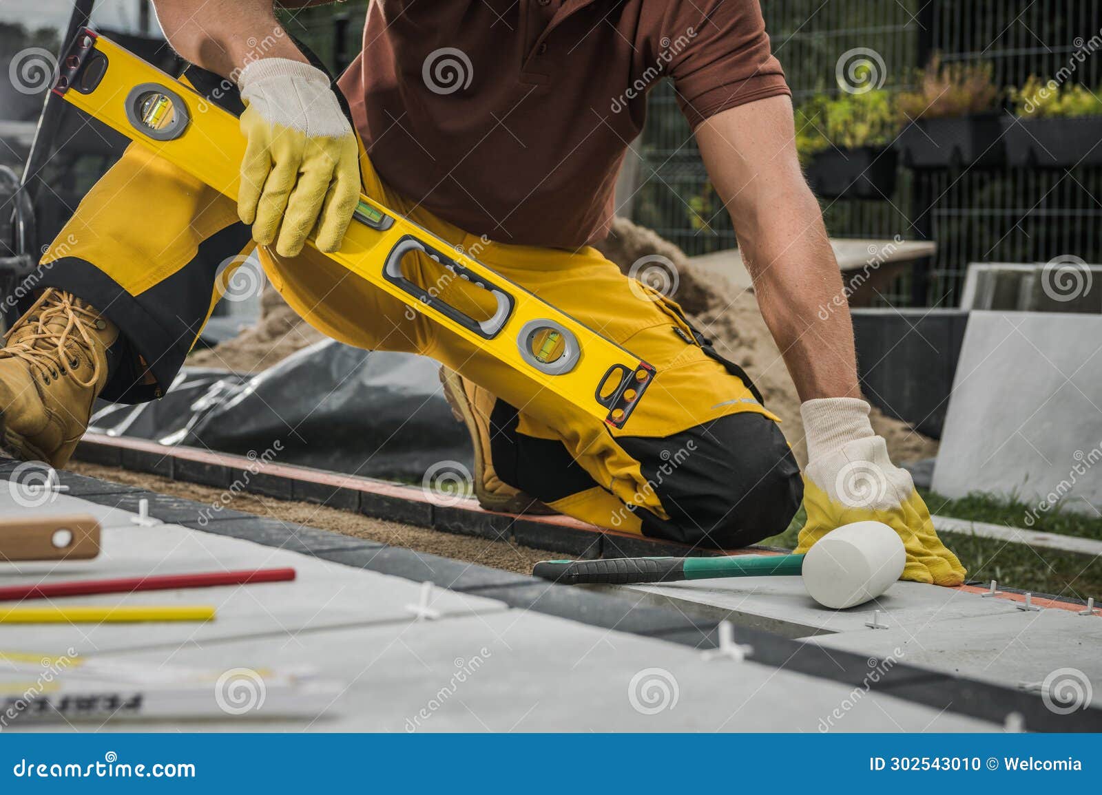 Worker with a Spirit Level Checking on a Patio Floor Levels Stock Photo ...