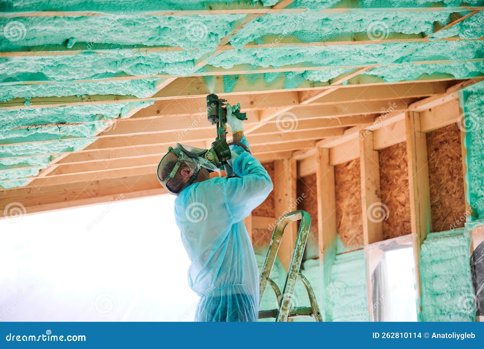 Worker Spraying Polyurethane Foam for Insulating Wooden Frame House ...