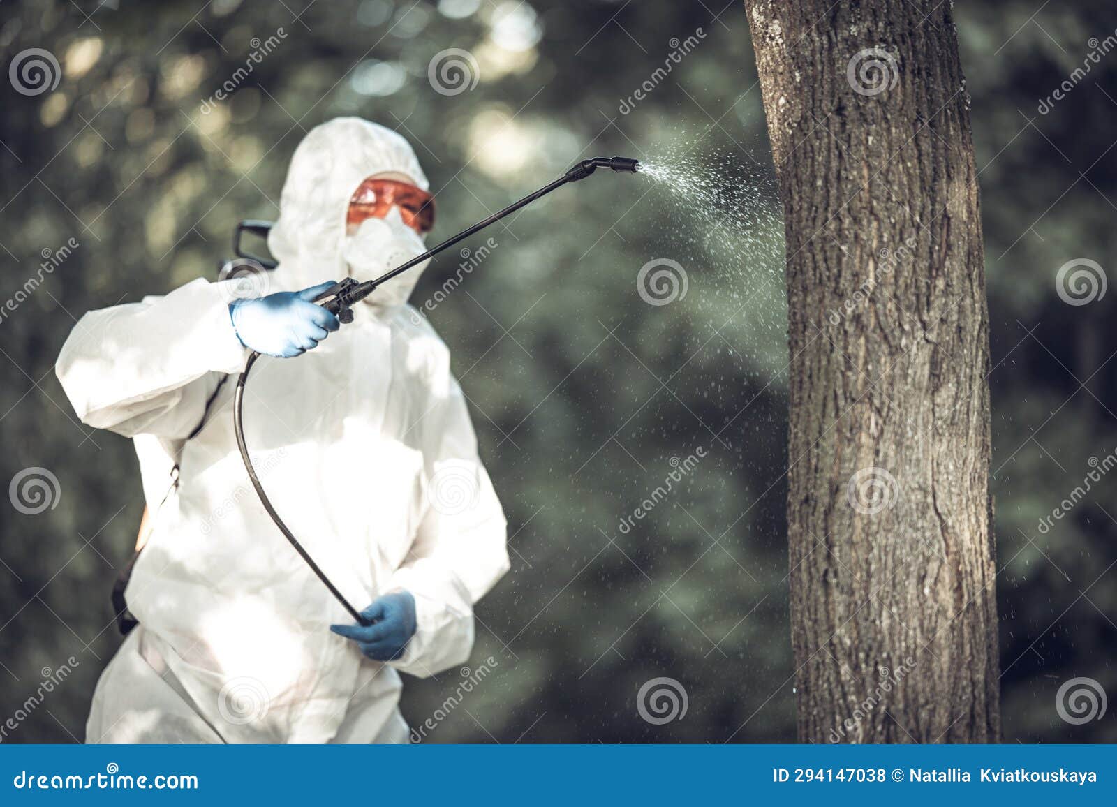 A Worker Sprays Pesticides on Trees Outdoors. Tree Pest Control Stock ...
