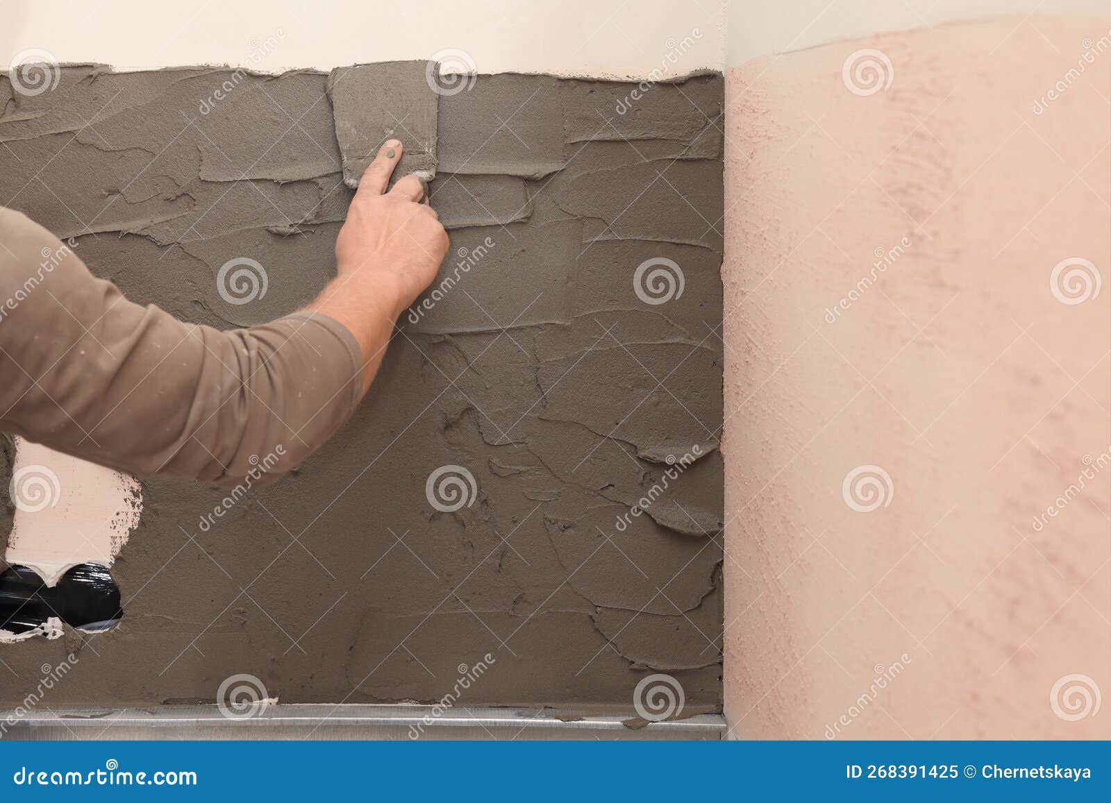 Worker Spreading Adhesive Mix for Installing Tile on Wall Indoors ...