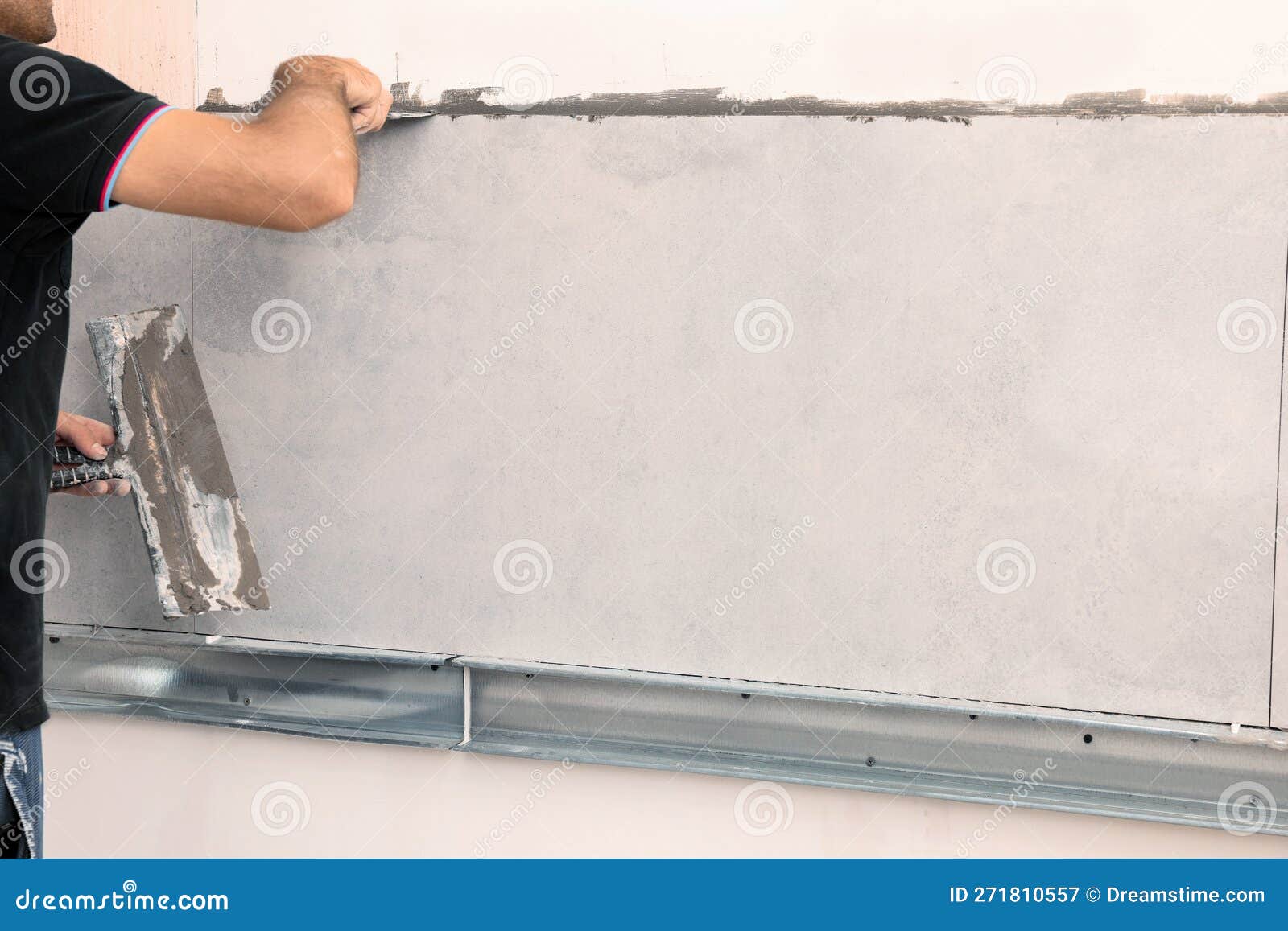 Worker Spreading Adhesive Mix on Wall for Tile Installation Indoors ...