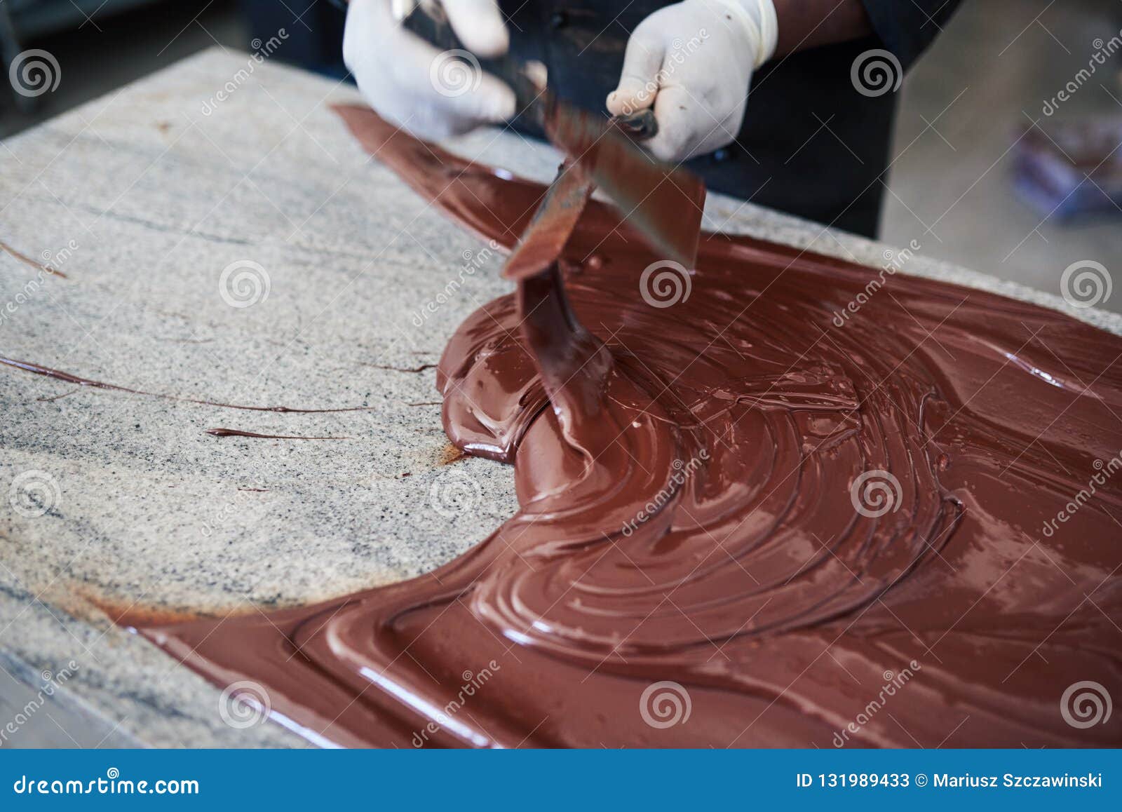 Worker Spreading Out Chocolate on a Table with Spatulas Stock Image ...