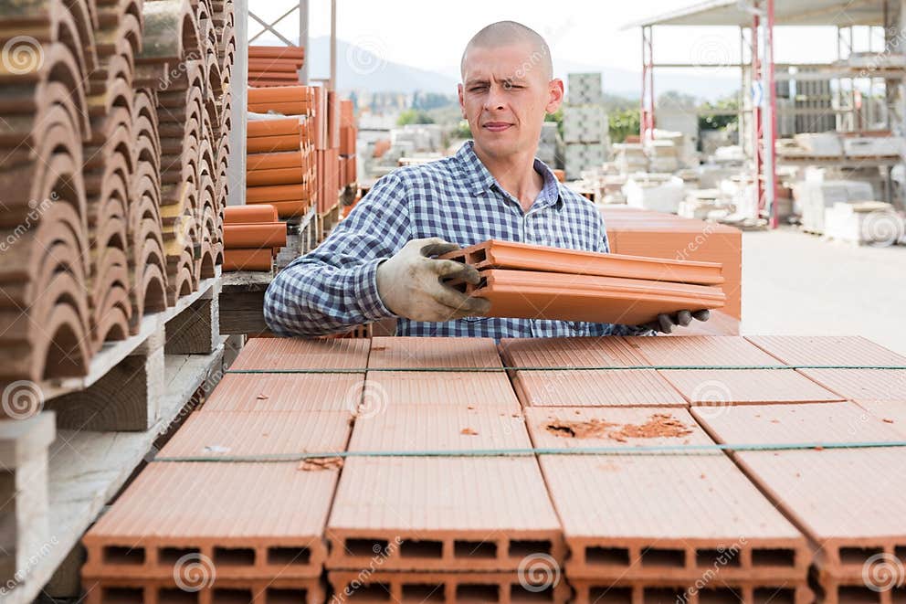 Worker Stacking Bricks in Warehouse of Materials Stock Photo - Image of ...