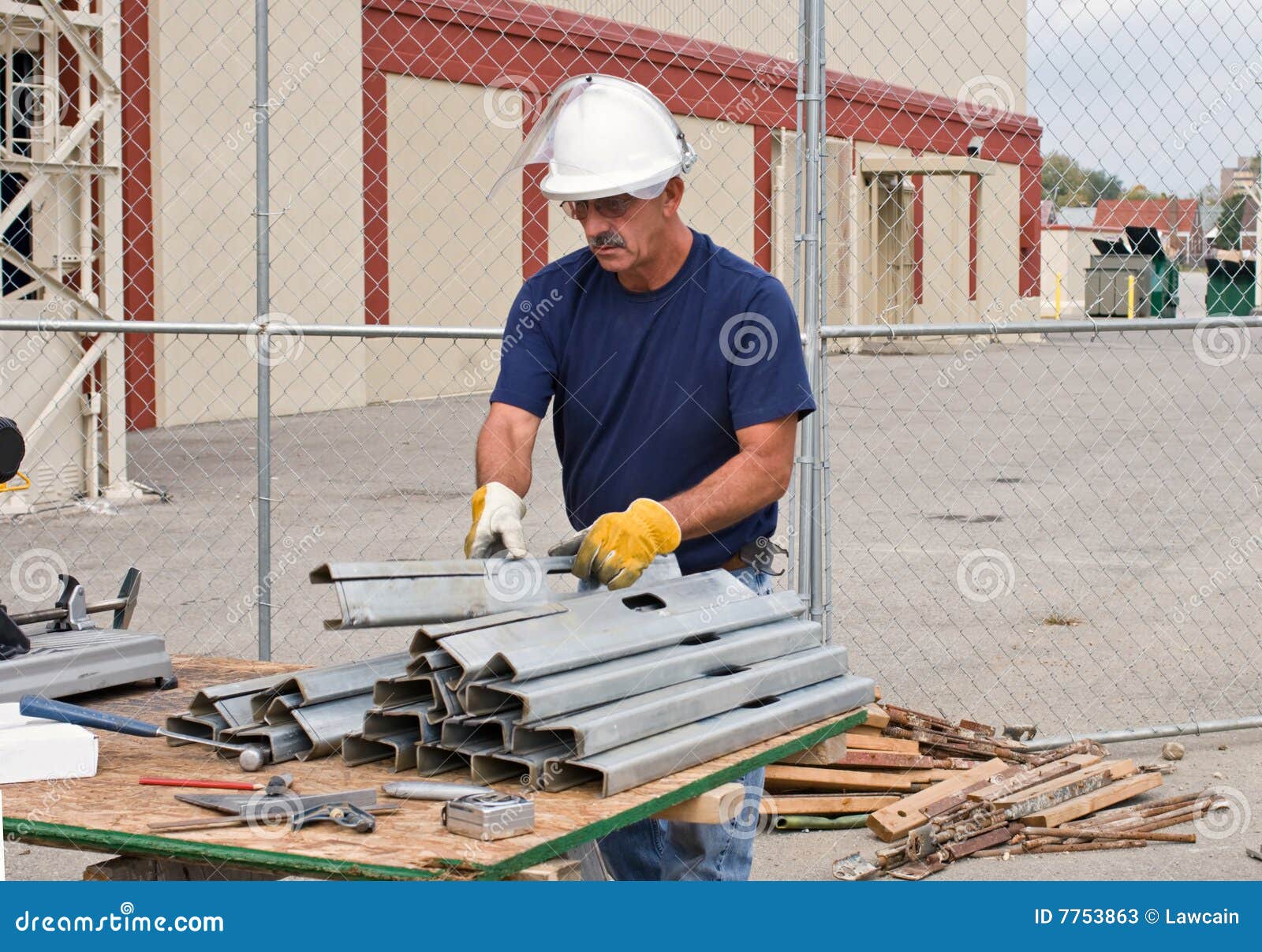 Worker Stacking Metal Studs Stock Image - Image of laborers, glasses ...