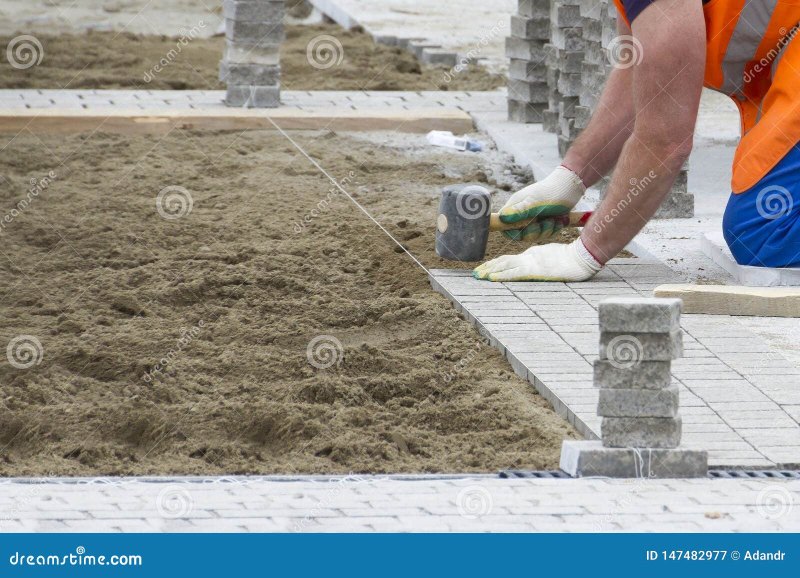 Worker Stacks Paving Slabs by Means of the Mallet Stock Image - Image ...