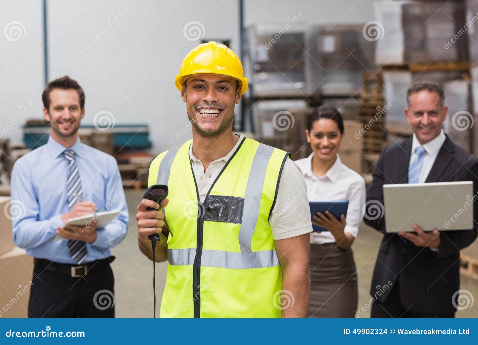 Worker Standing with Scanner in Front of His Colleagues Stock Photo ...