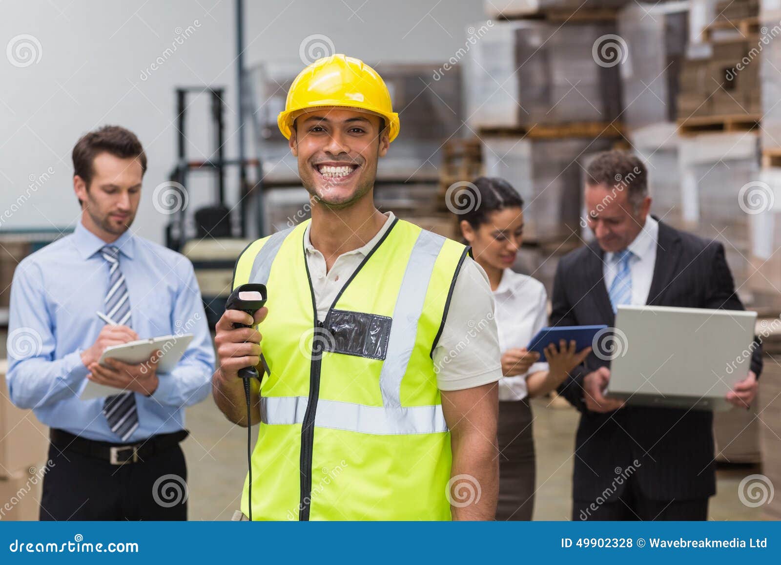 Worker Standing with Scanner in Front of His Colleagues Stock Photo ...