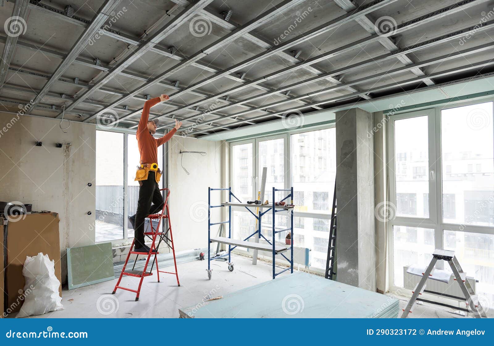 Worker Stands on a Ladder and Make a Ceiling Stock Photo - Image of ...