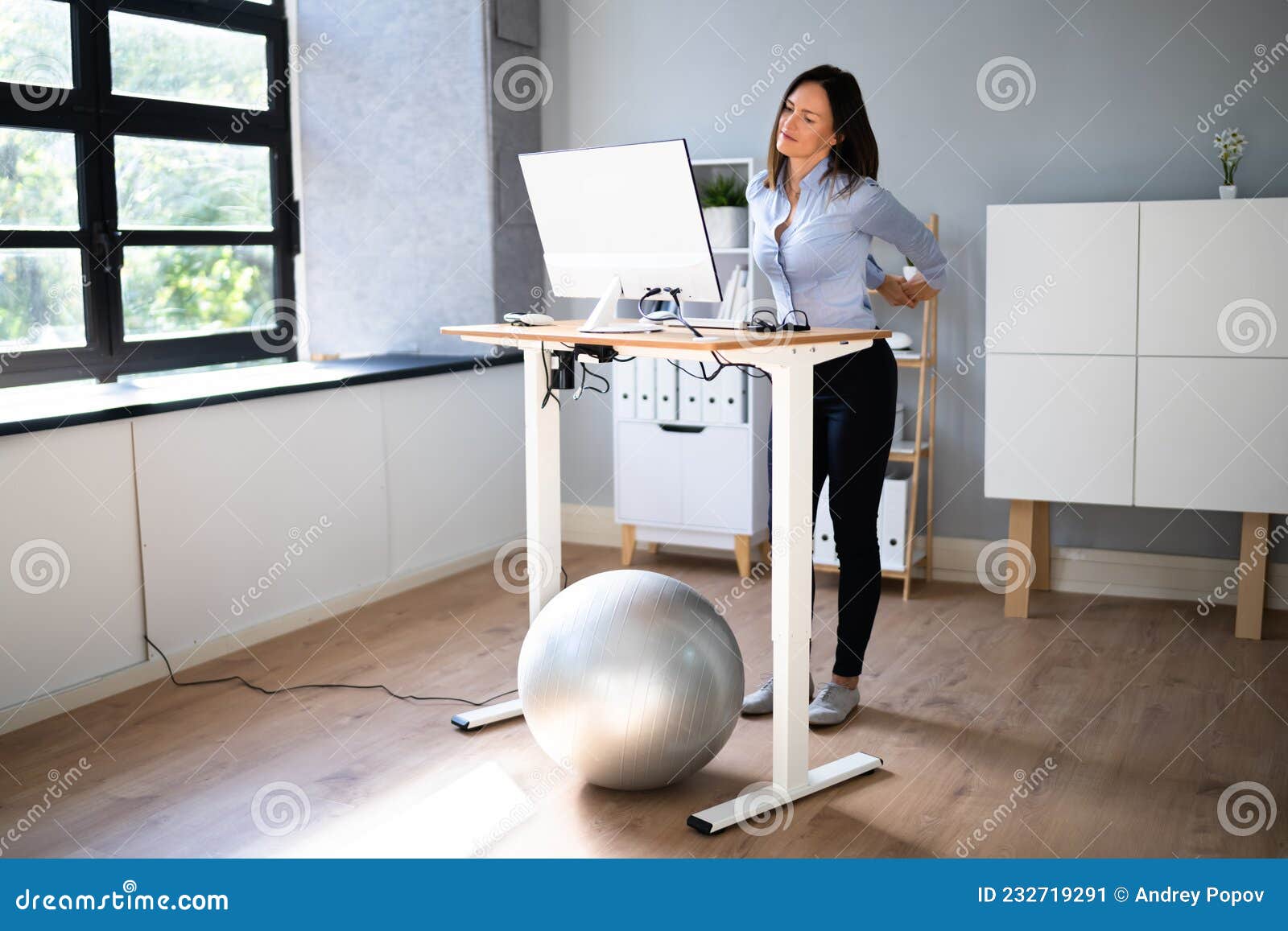 Worker Stretch Exercise at Stand Desk Stock Image - Image of height ...