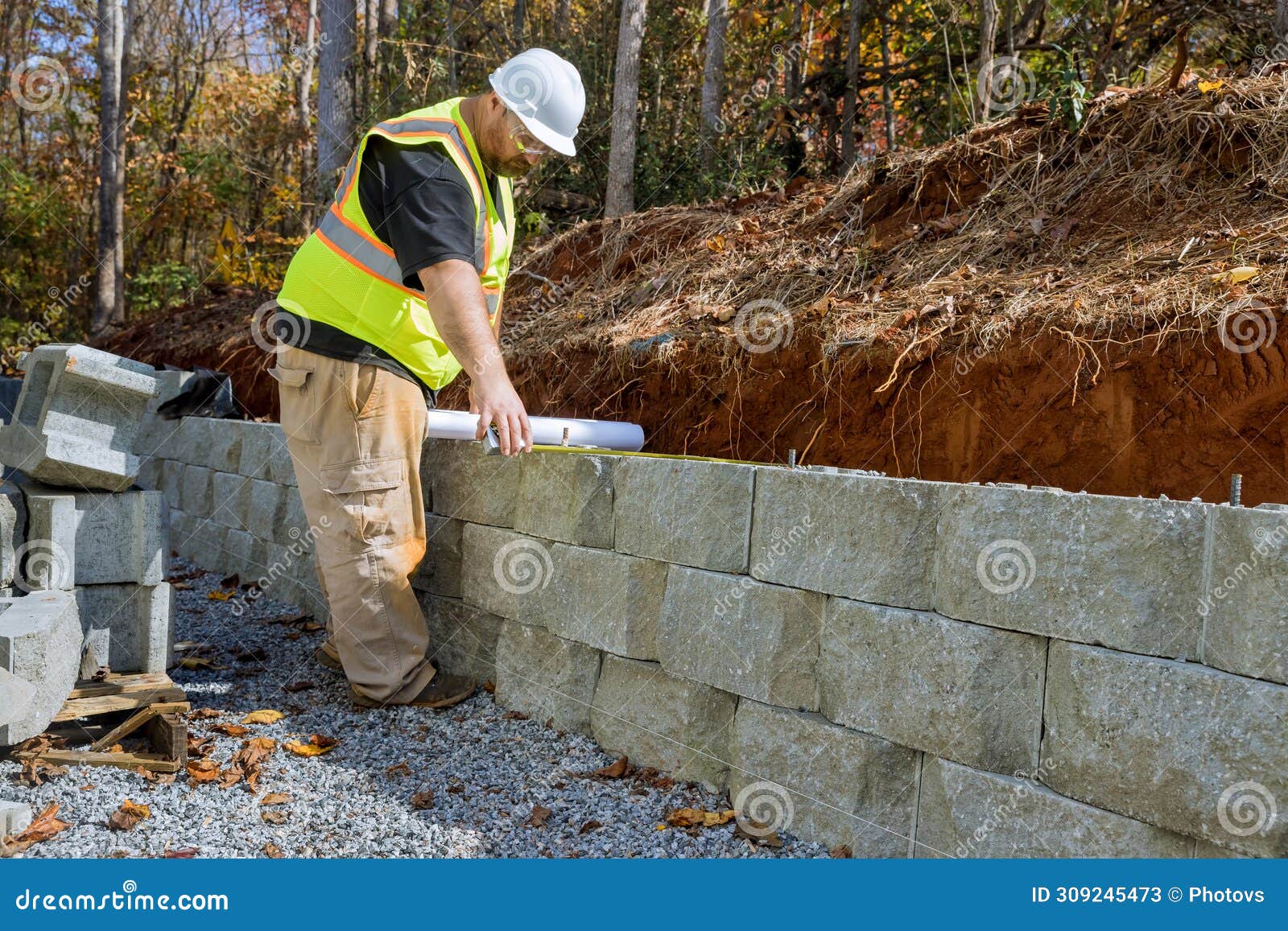 Worker Studied Blueprint Plans when Mounting Retaining Walls Using ...