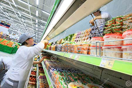 Worker in supermarket editorial photography. Image of market - 13327462