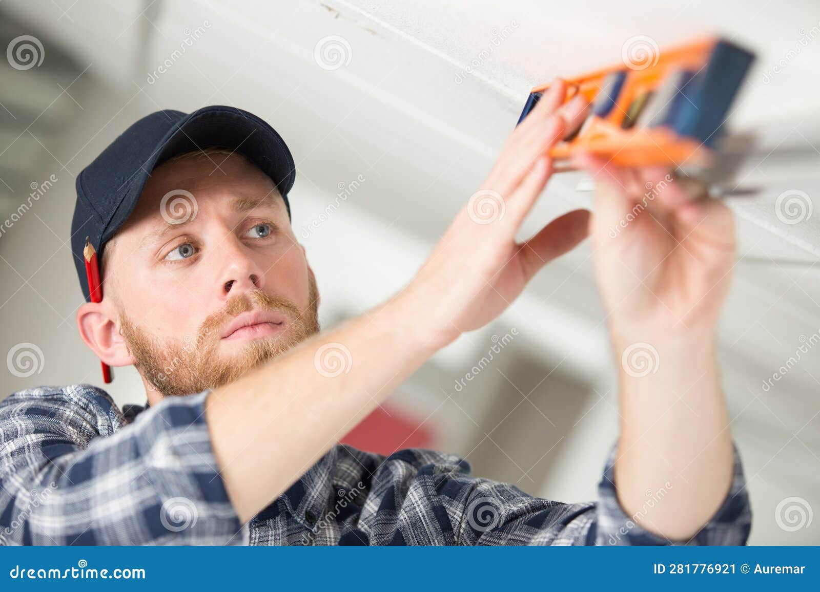 Worker Taking Ceiling Measures with Spirit Level Stock Image - Image of ...
