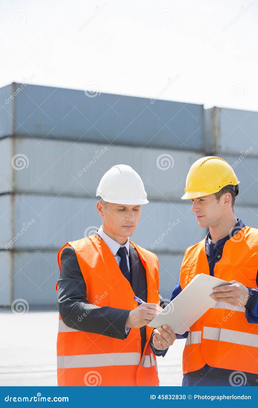 Worker Taking Sign of Supervisor on Clipboard in Shipping Yard Stock ...