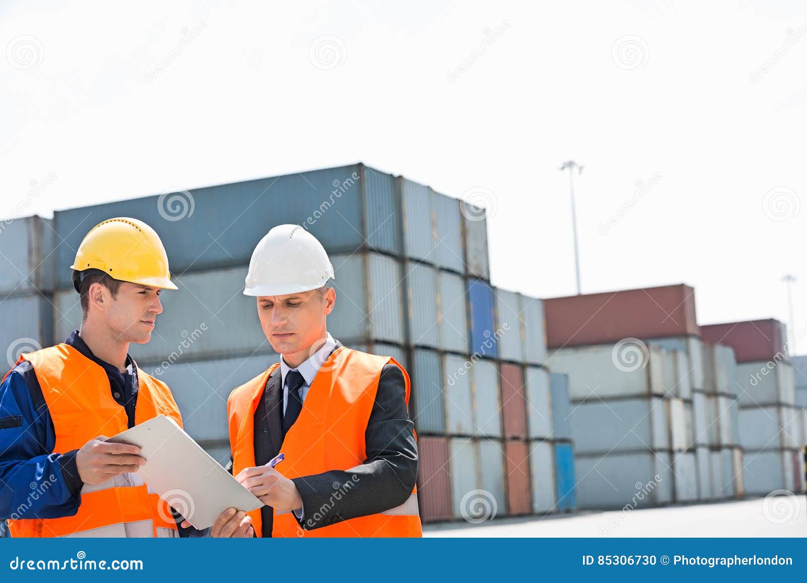 Worker Taking Sign of Supervisor on Clipboard in Shipping Yard Stock ...